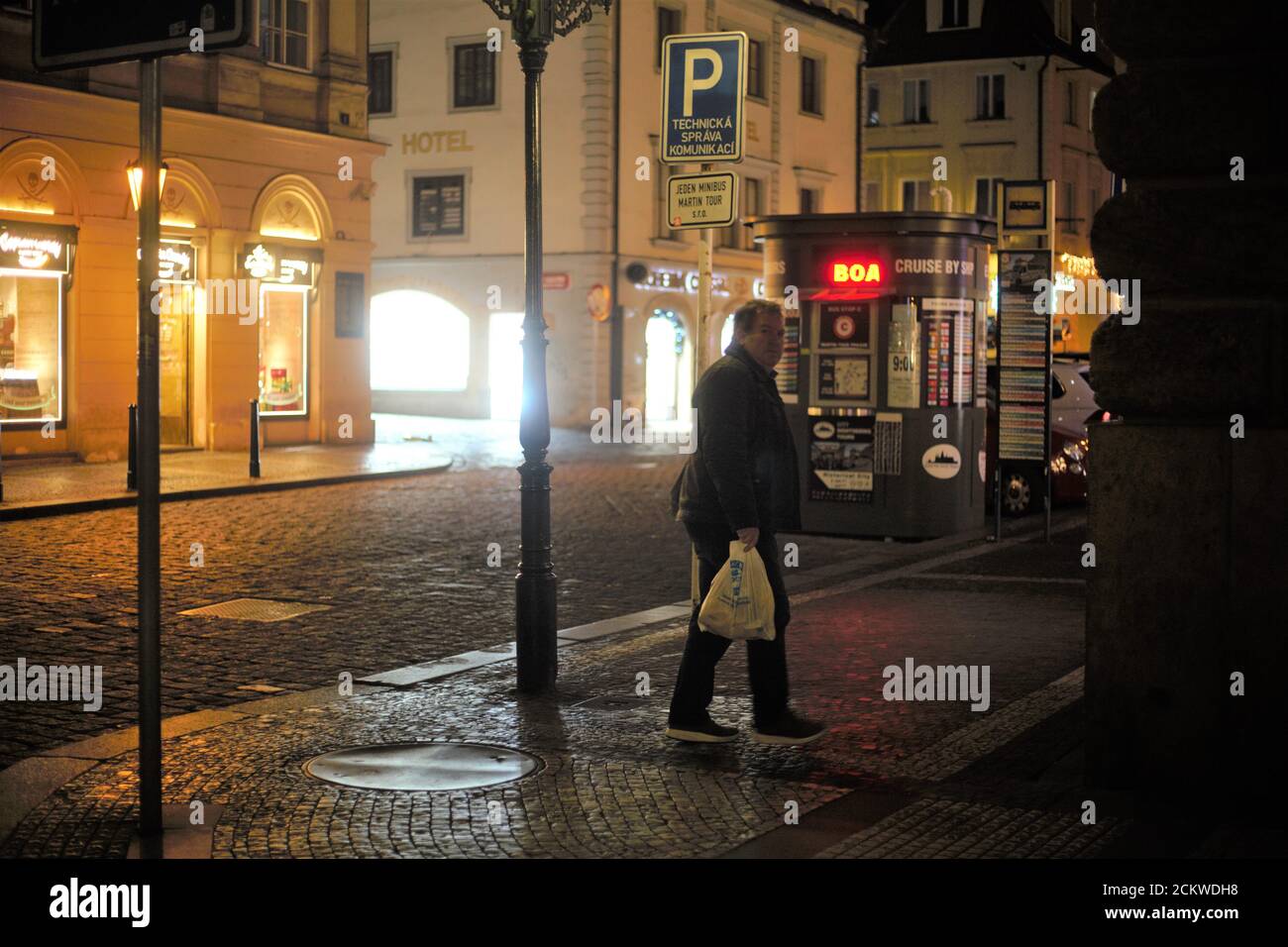 Street Photography - View of a man at night in a street looking back ...