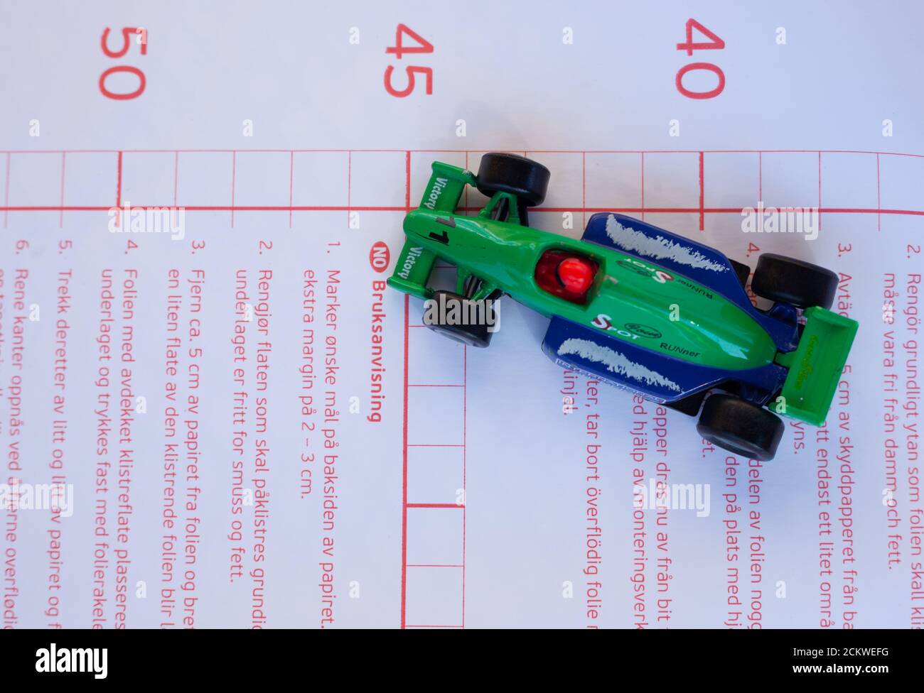 Concept / Abstracts - View of a toy racing car on graph paper ...