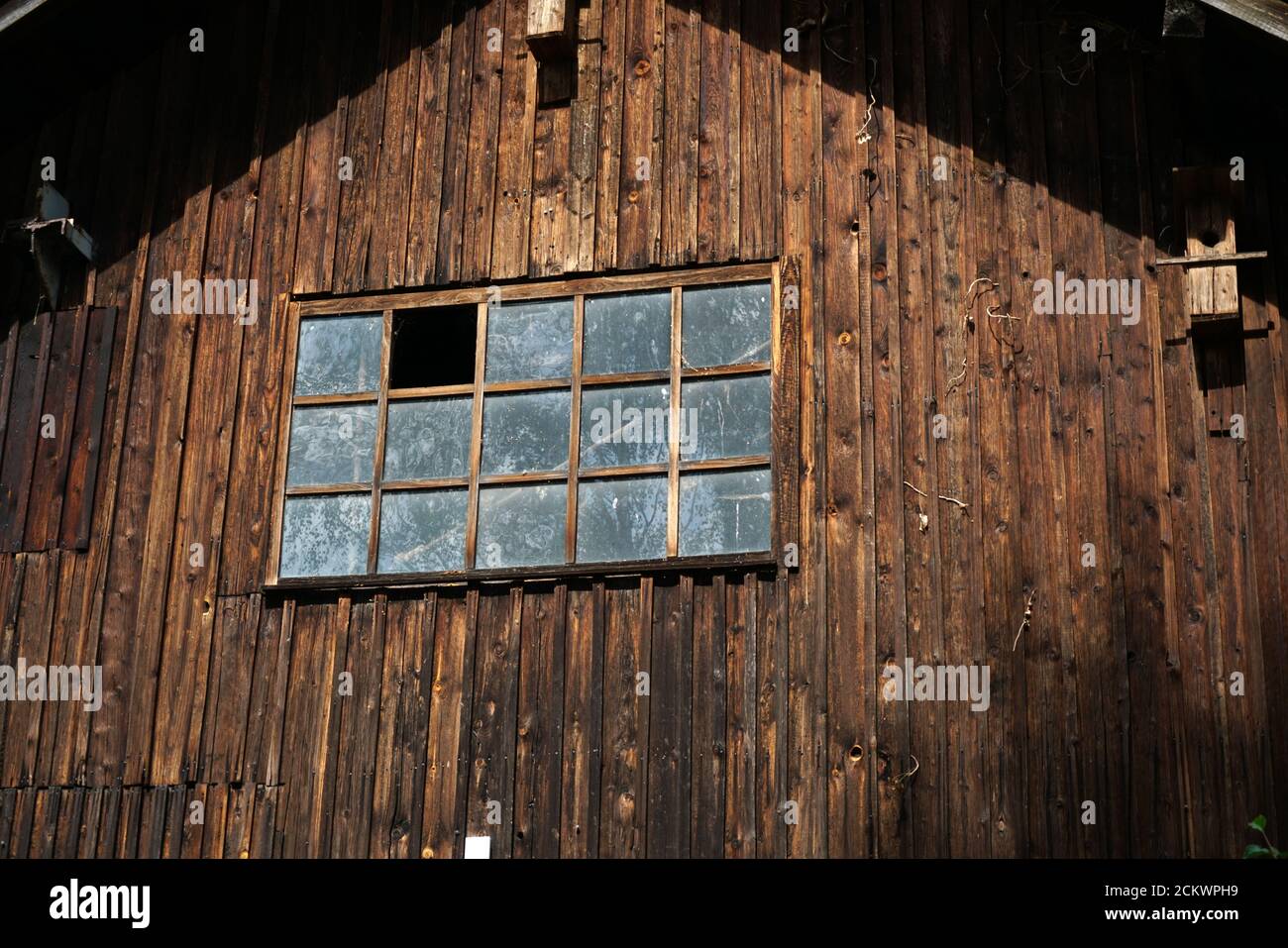 Old wooden house with a broken window Stock Photo - Alamy