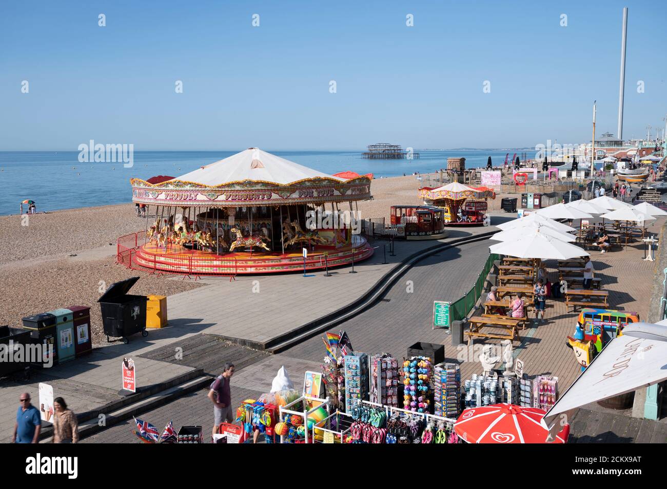 Brighton Beach with tourists enjoying the attractions like the carousel ...