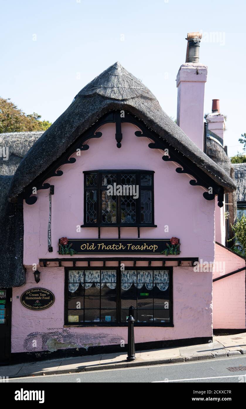 Pink painted exterior of the Old Thatch Tearoom, thatched building ...