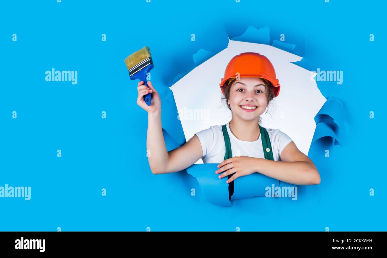 girl in protective helmet painting the wall. childhood development. Kid ...