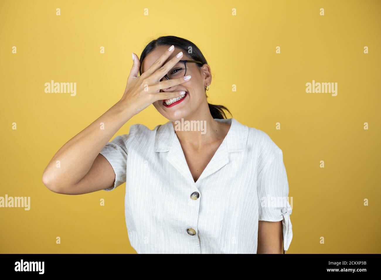 Hand over eyes peeking woman hi-res stock photography and images - Alamy