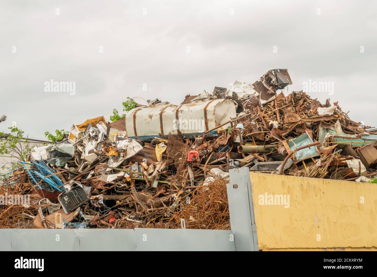 Scrap metal waste is stored in a recycling yard waiting to be melted ...