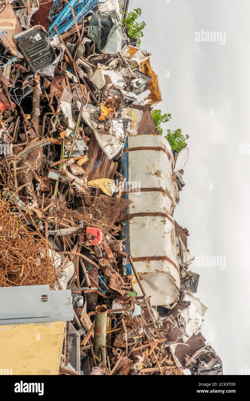 Scrap metal waste is stored in a recycling yard waiting to be melted ...