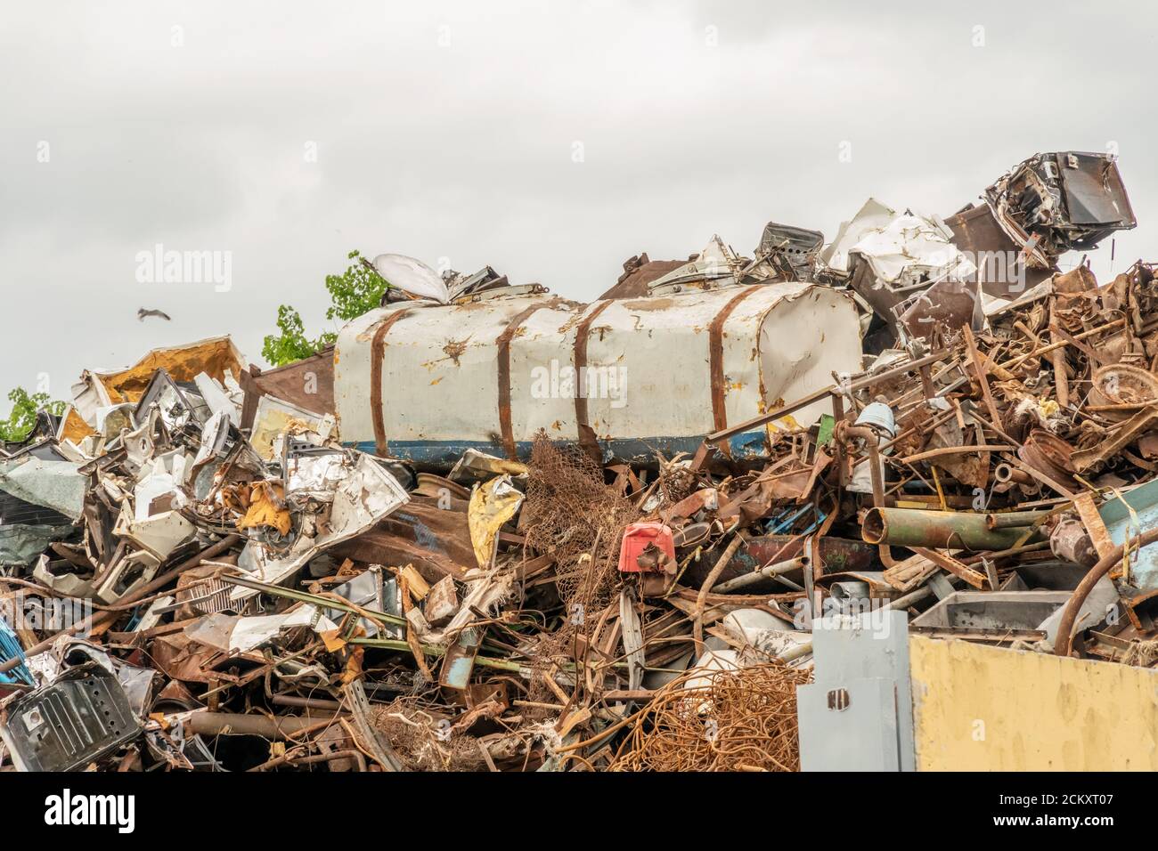 Scrap metal waste is stored in a recycling yard waiting to be melted ...