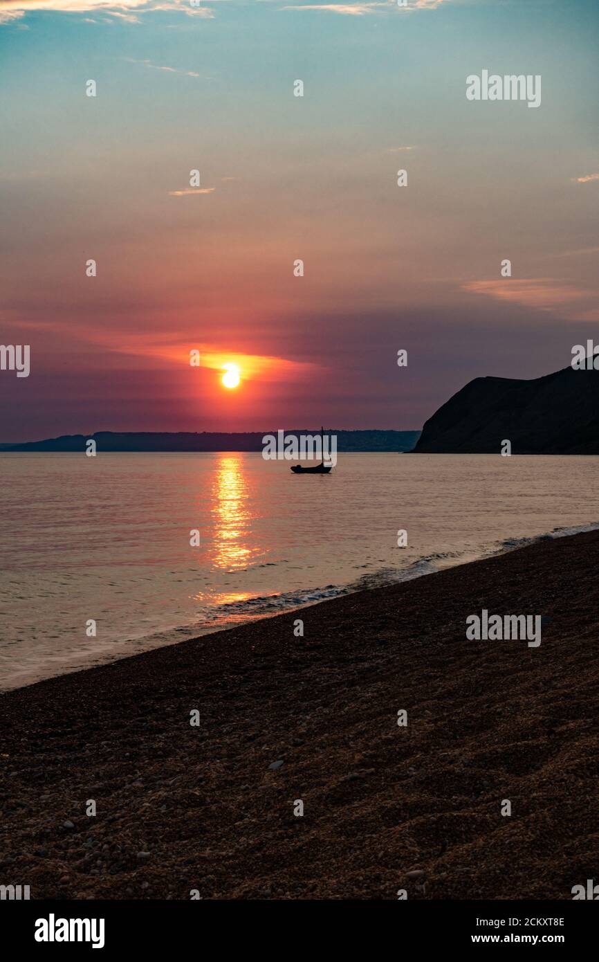 Dinghy at Eype beach at sunset, Dorset, UK Stock Photo - Alamy