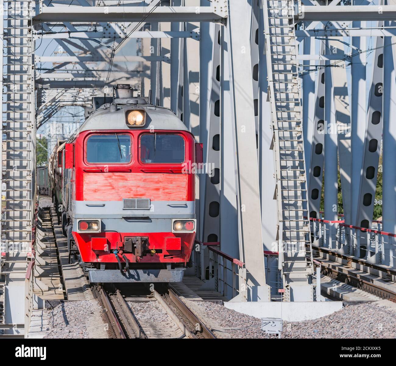 Diesel freight train moves through the bridge Stock Photo - Alamy