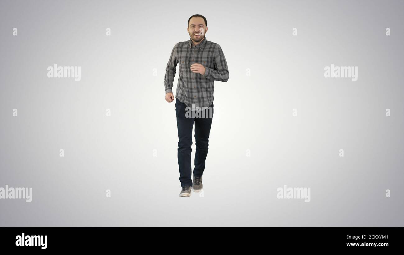 Young man running excited on gradient background Stock Photo - Alamy
