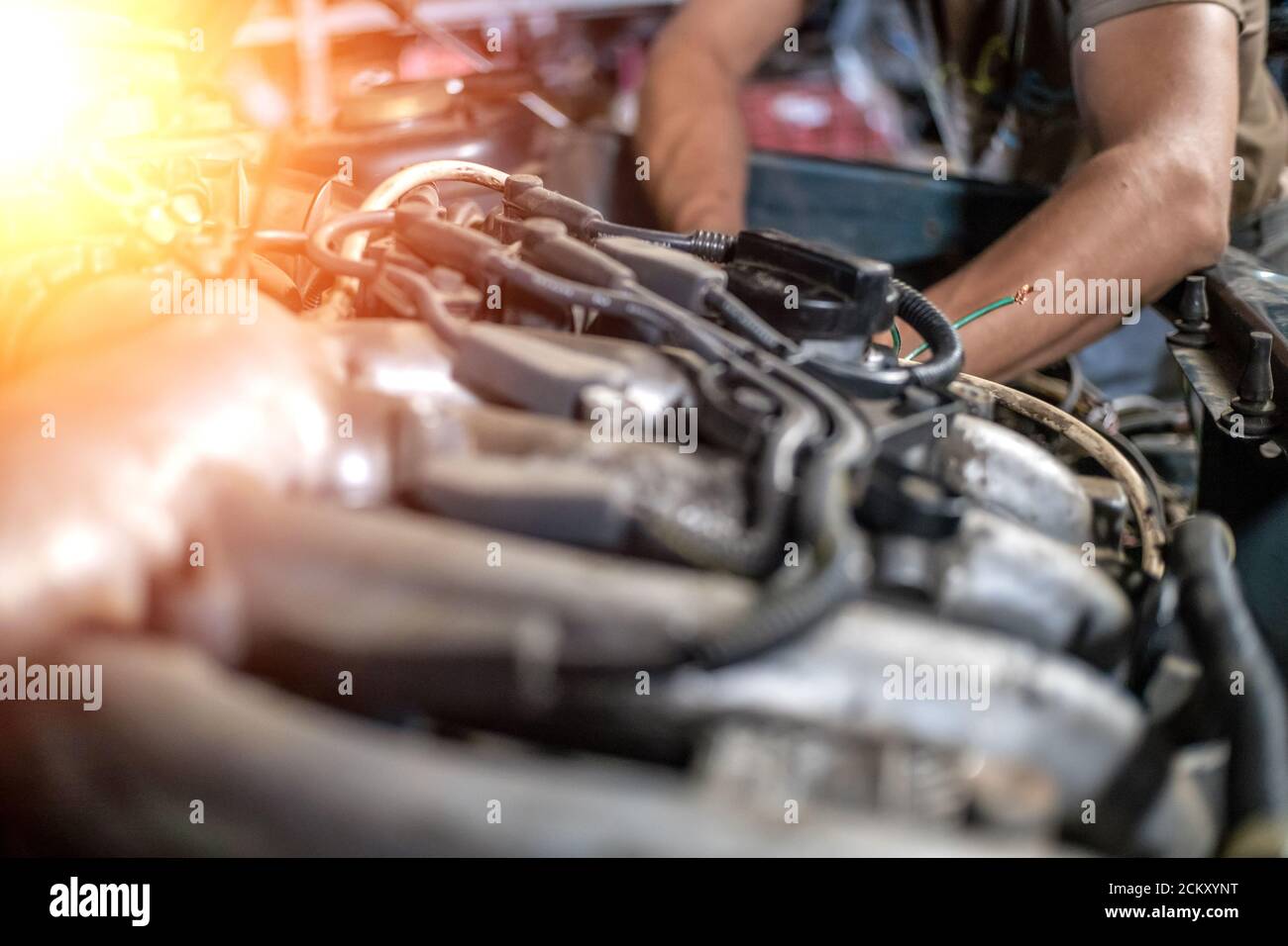 hands of mechanic repairing the car's engine close up, photo with ...