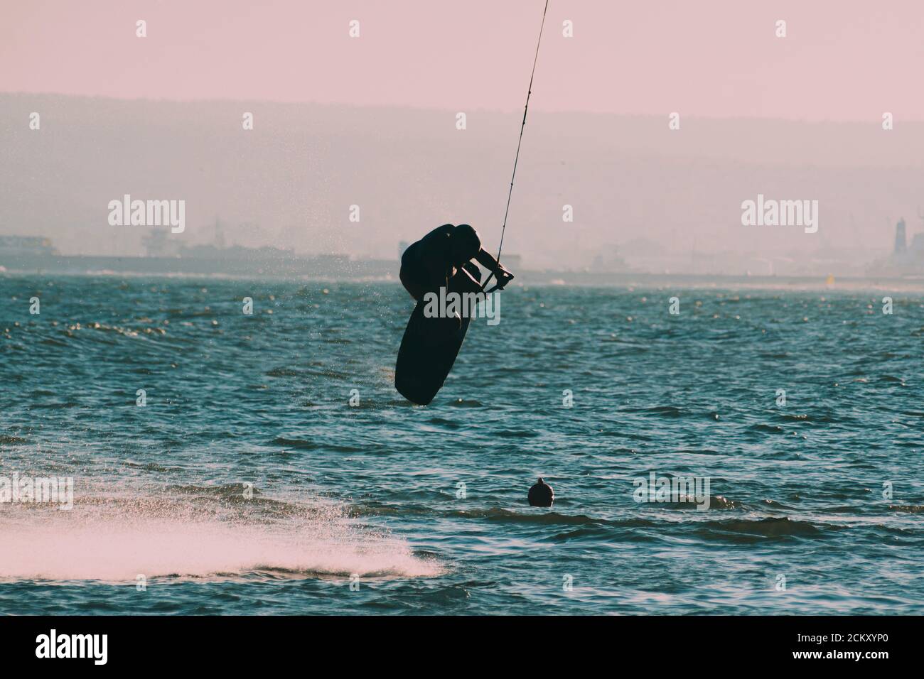 WAKEBOARDING AT THE SEA JUMPING HIGH DOING A BACKFLIP Stock Photo - Alamy