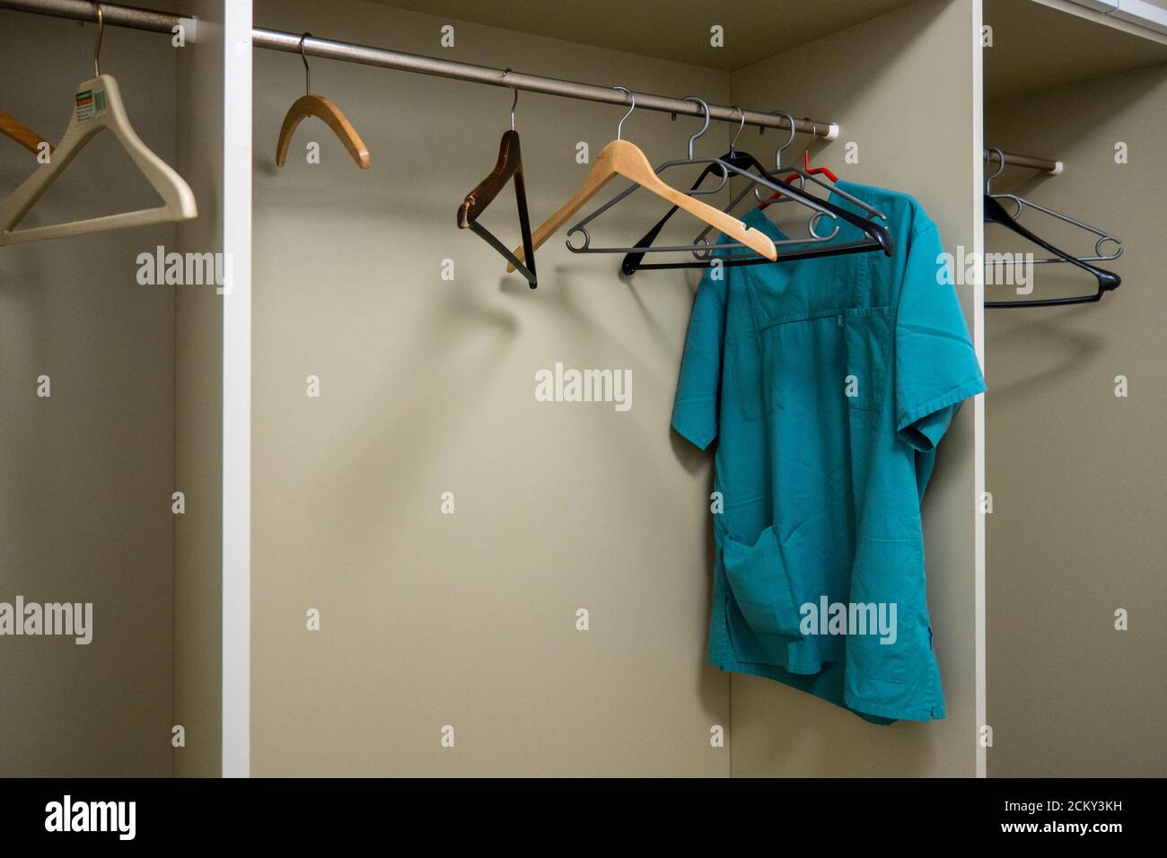 in the changing room in an operating room hangs green surgical clothing ...