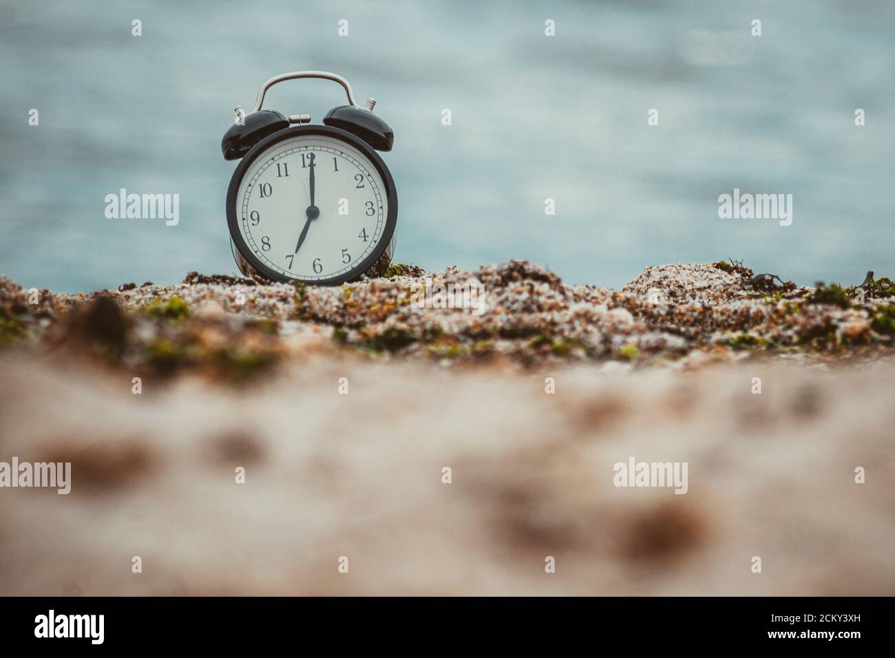 ALARM CLOCK AT THE BEACH WITH TRENDING COLORS. CONCEPT OF SUMMER ENDING ...