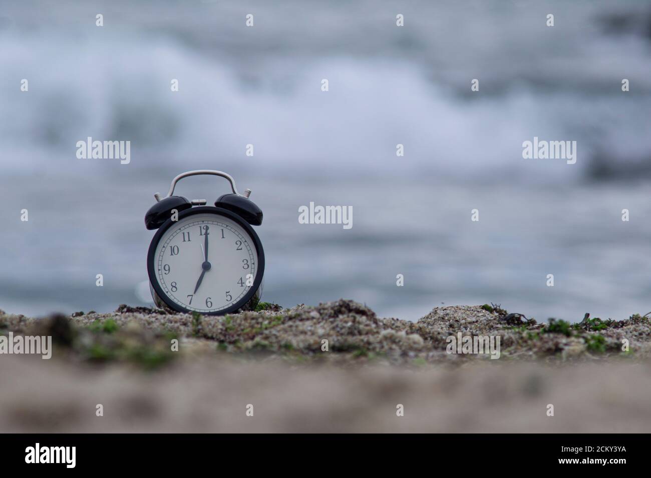 ALARM CLOCK AT THE BEACH WITH TRENDING COLORS. CONCEPT OF SUMMER ENDING ...