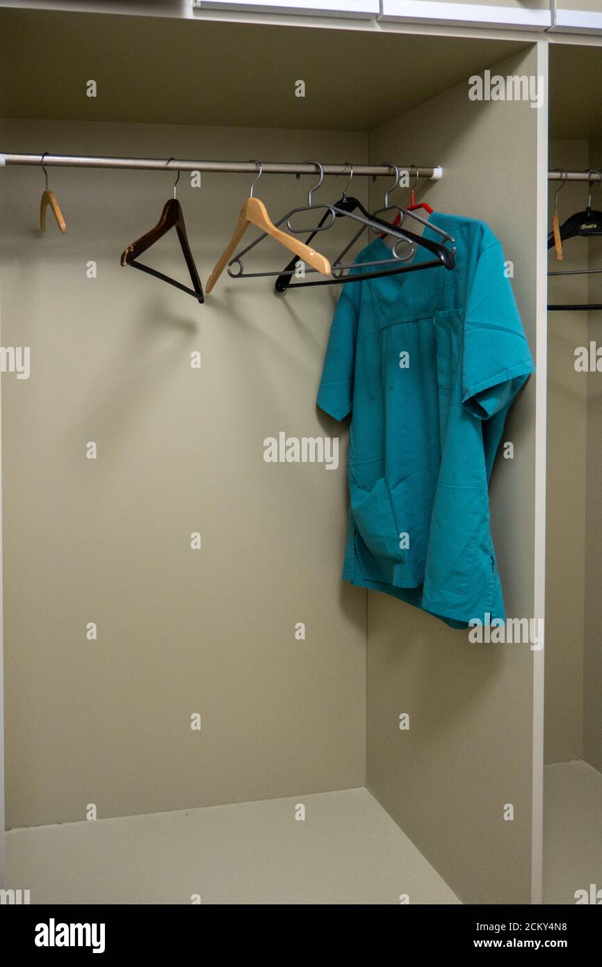 in the changing room in an operating room hangs green surgical clothing ...