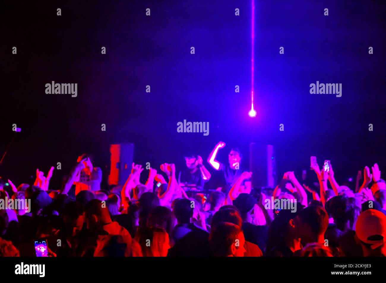 Crowd and DJs dancing during party Stock Photo - Alamy