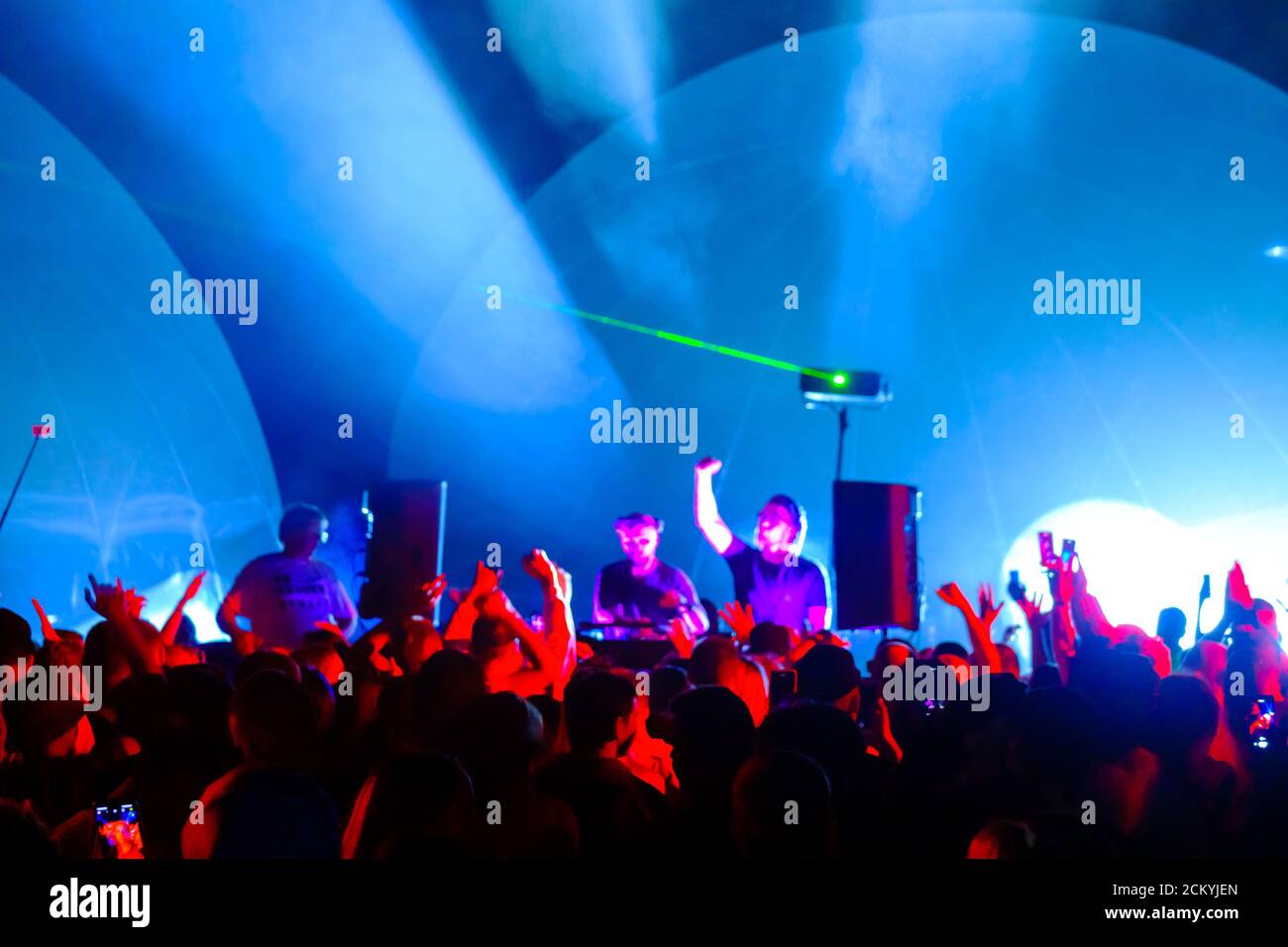 Crowd and DJs dancing during party Stock Photo - Alamy