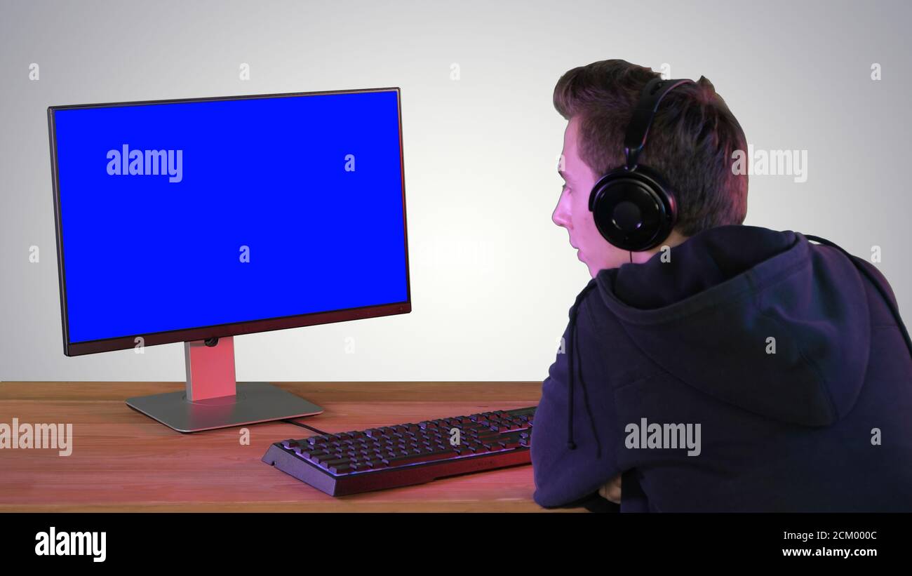 Professional Gamer Looking At His Personal Computer on gradient Stock ...