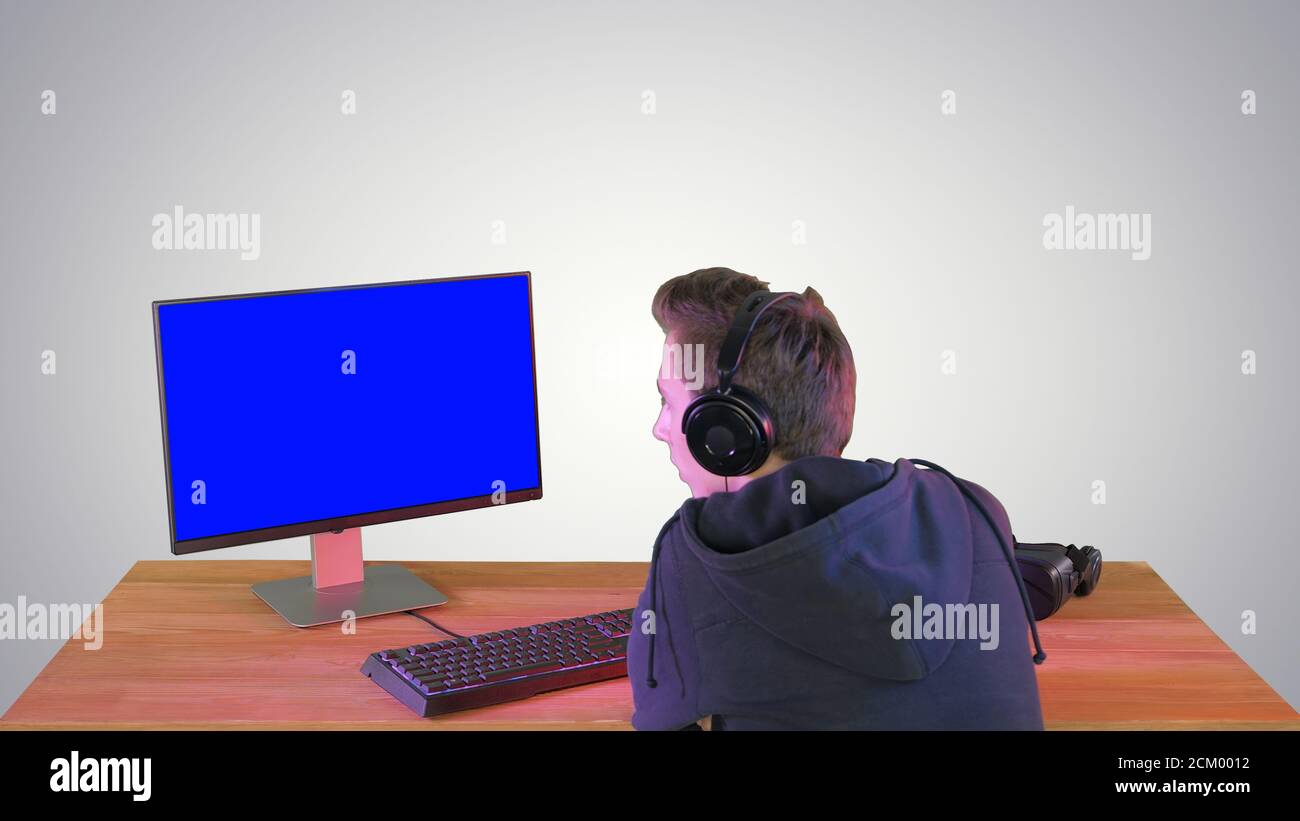 Professional Gamer Looking At His Personal Computer on gradient Stock ...