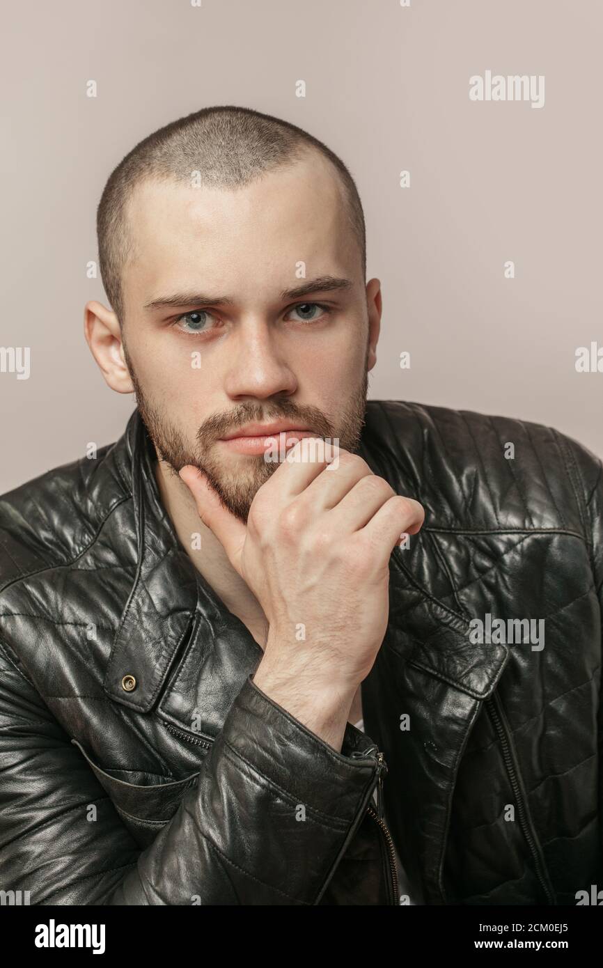 pensive strong guy touching his chin.close up portrait. fit man with ...