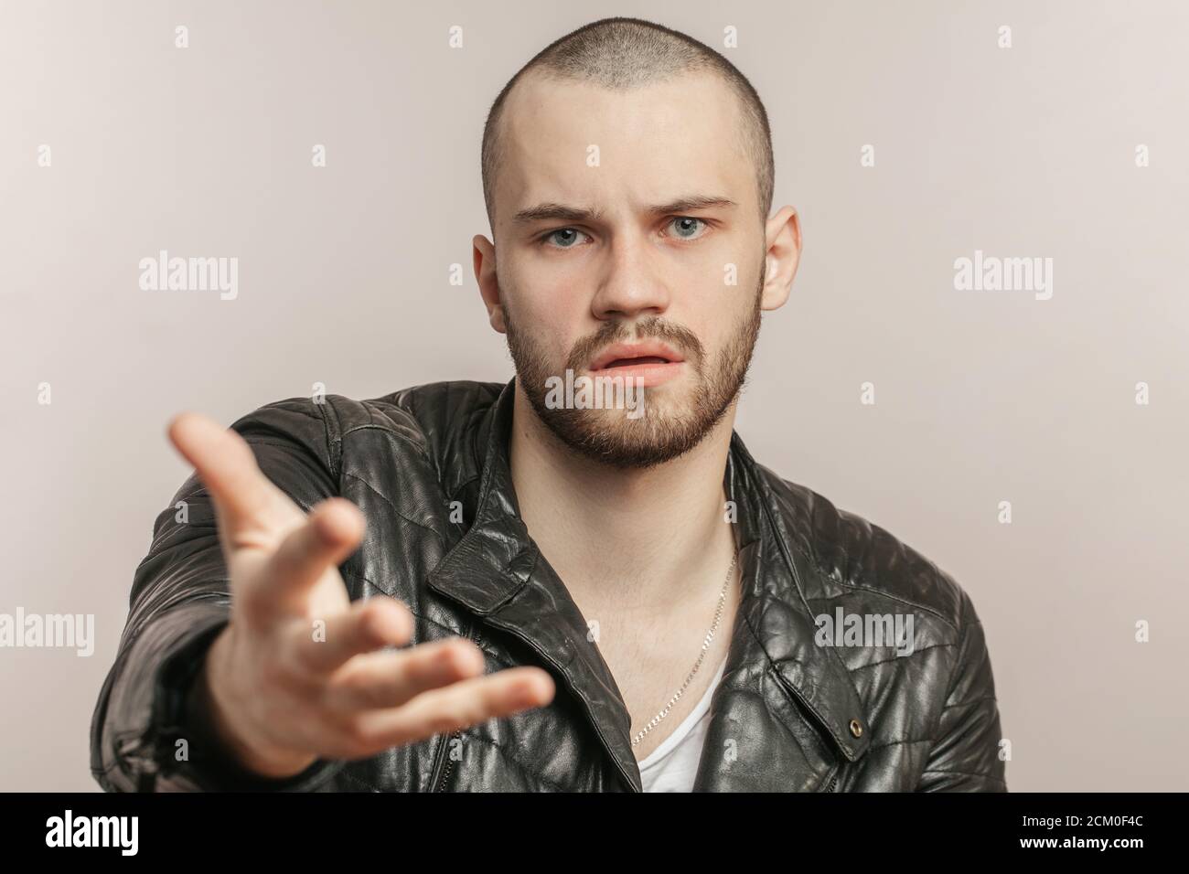 good looking man in leather jacket is offering help. man asking advice ...