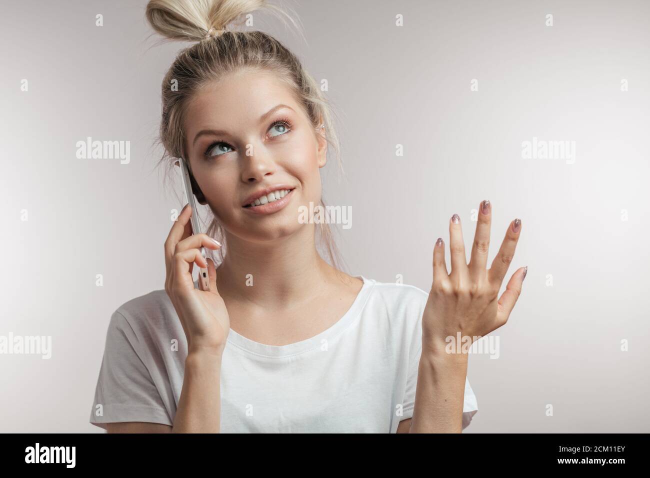 Thoughtful confused upset puzzled attracted caucasian woman holding her ... Thoughtful confused upset puzzled attracted caucasian woman holding her ...
