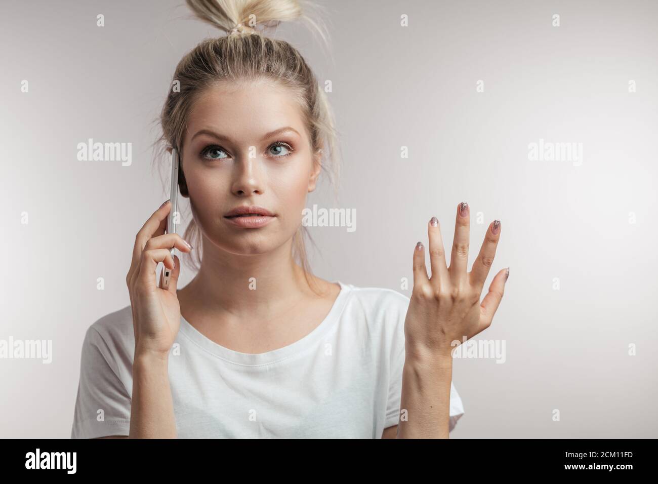 Thoughtful confused upset puzzled attracted caucasian woman holding her ...
