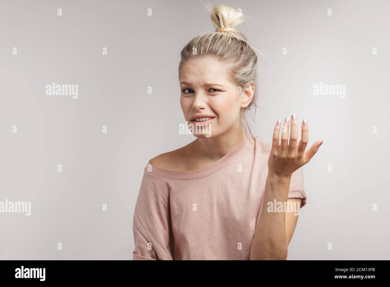 Human emotions and gestures concept. Attractive young woman with blonde ...