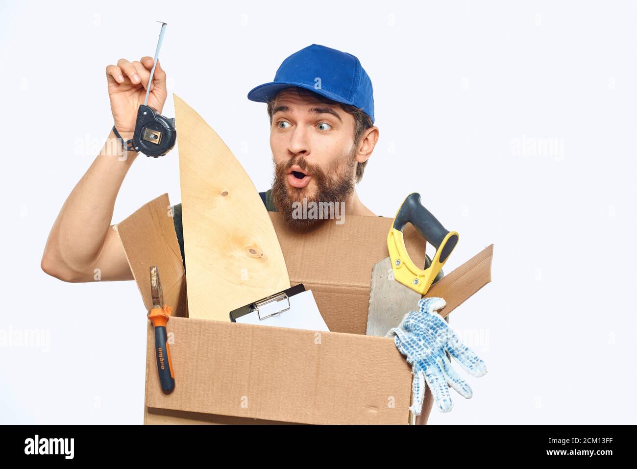 Worker man in uniform with a box in his hands tools delivery service ...