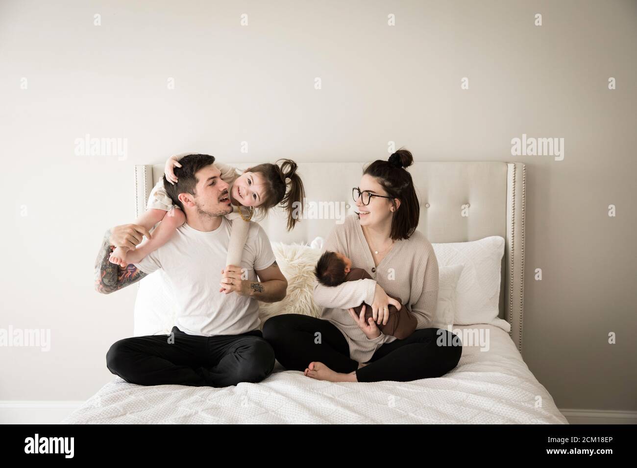 Happy Millennial Family Plays Together on Bed Stock Photo - Alamy