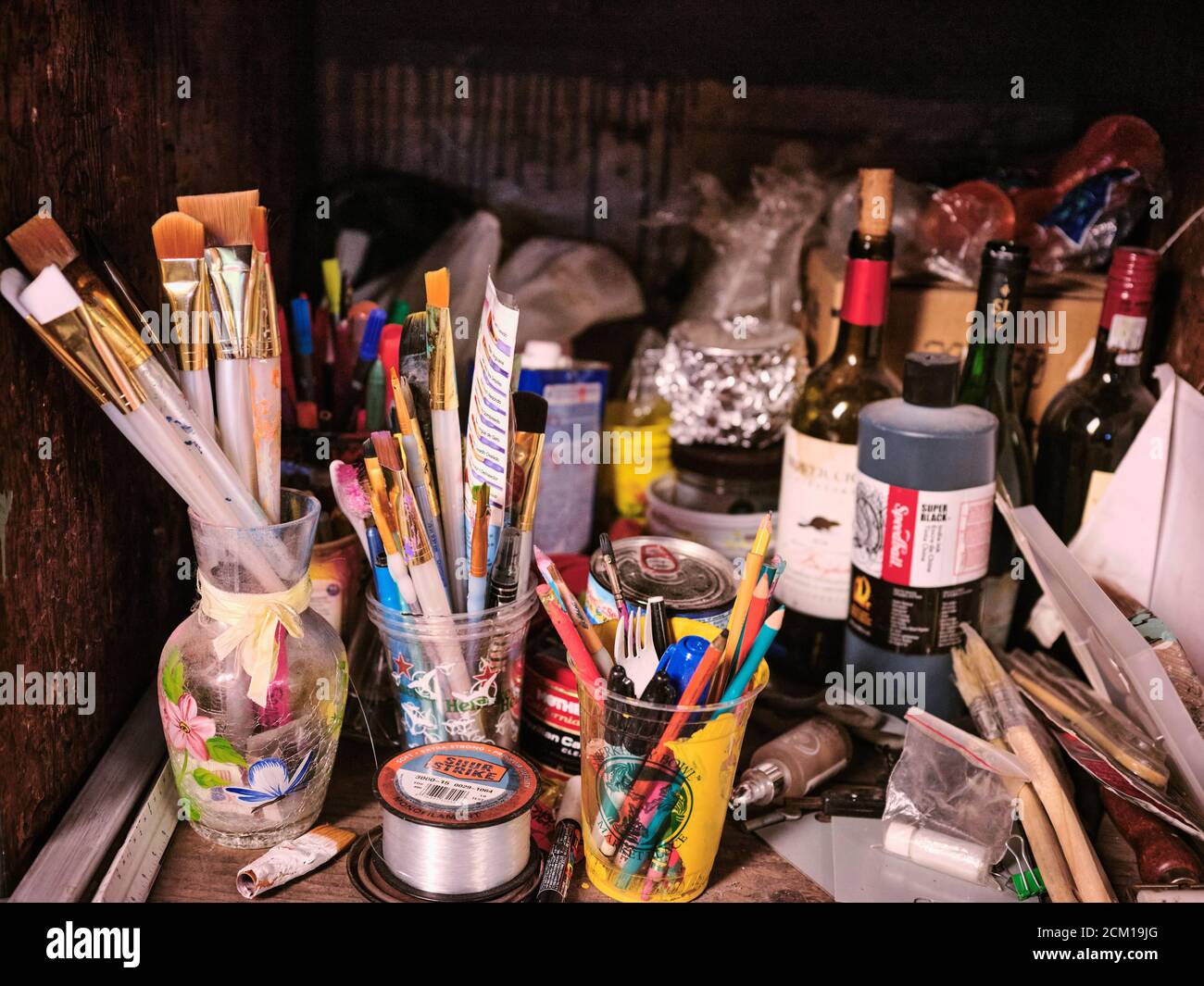 Paintbrushes and other objects and clutter in an artists studio Stock ...