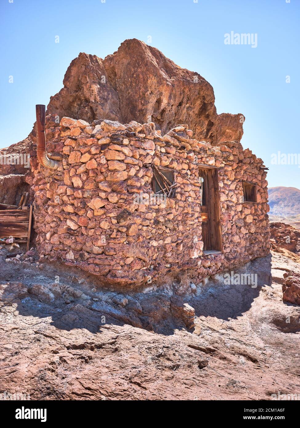 An abandoned rock house sits vacant in an old ghost town Stock Photo ...