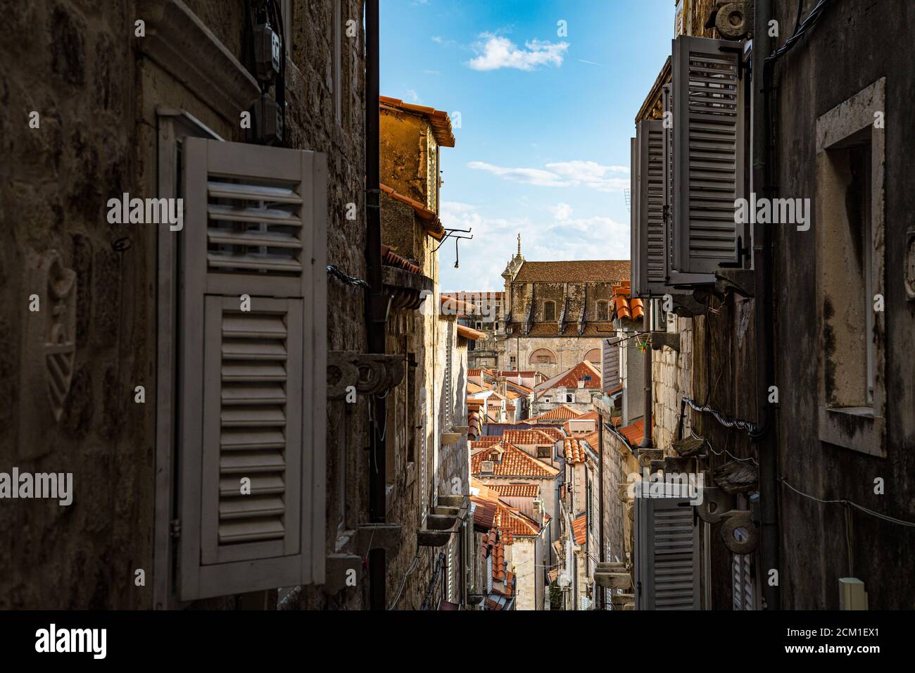 Open white windows in alley with rooftops and blue sky background Stock ...