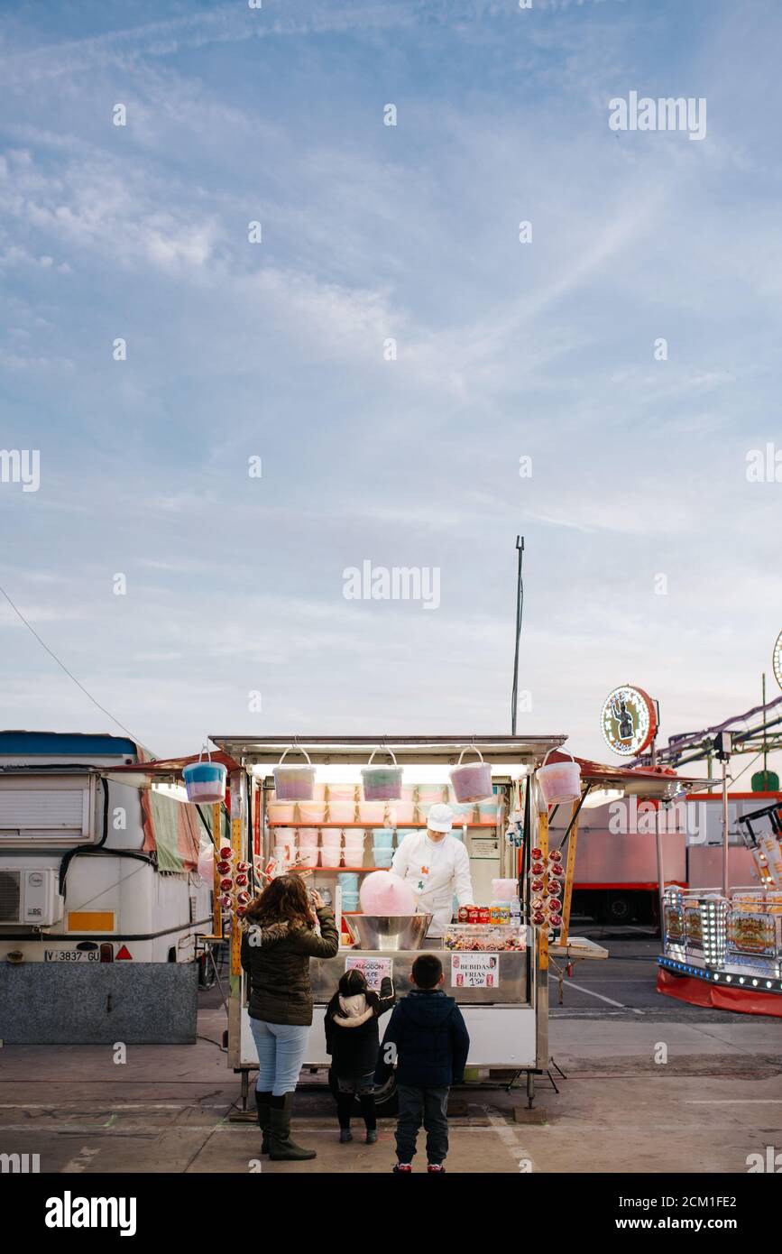 Small candy shop in a funfair with 2 kids watching cotton candy Stock ...