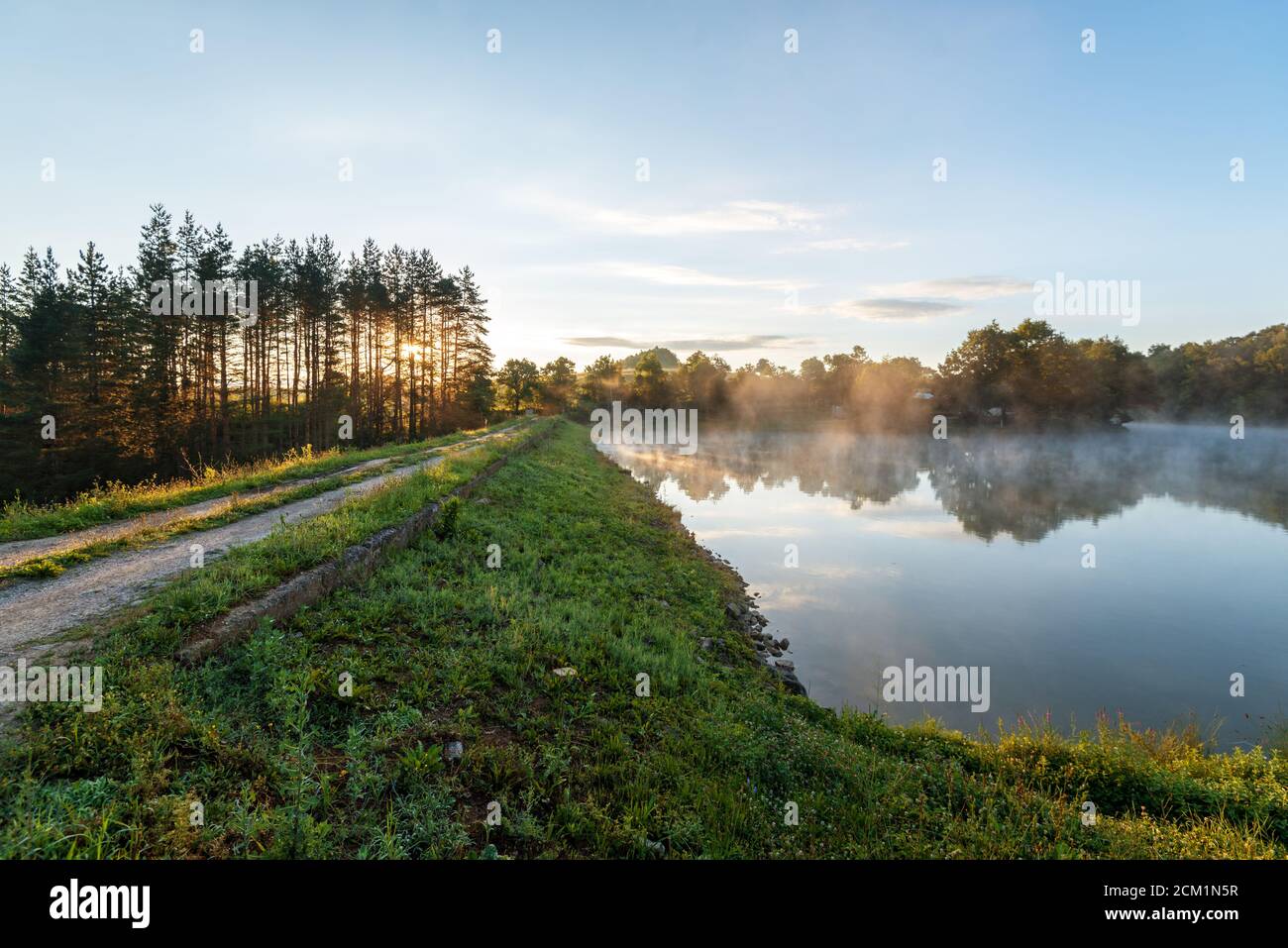 Morning fog on the forest lake, sunrise shot Stock Photo - Alamy
