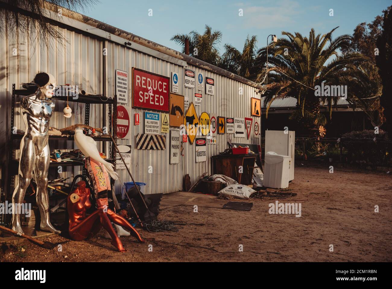 Shed with road signs and broken mannequins with electrical junk Stock ...