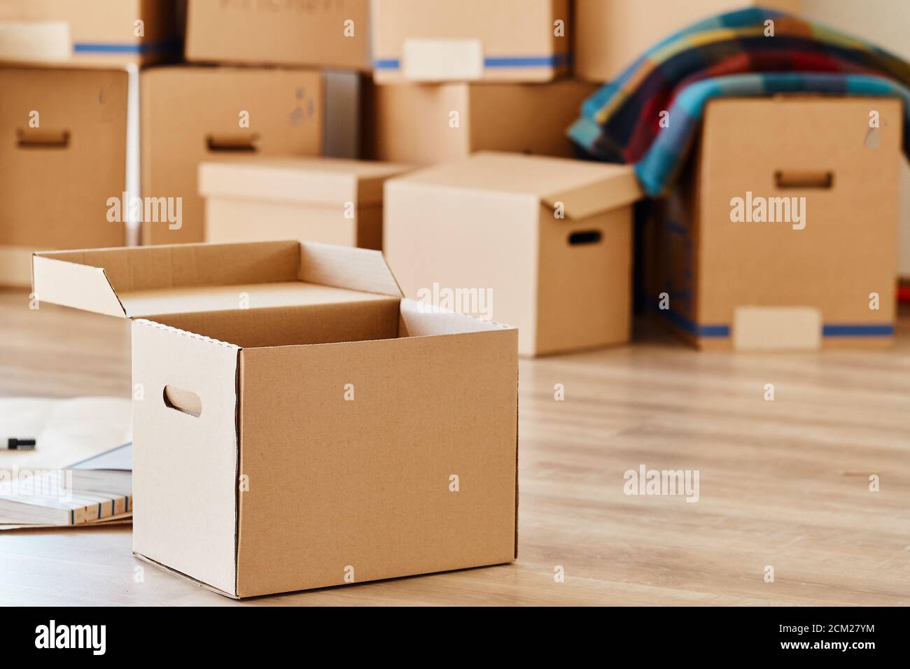 Moving in. Stack of cardboard boxes in room of new home Stock Photo - Alamy