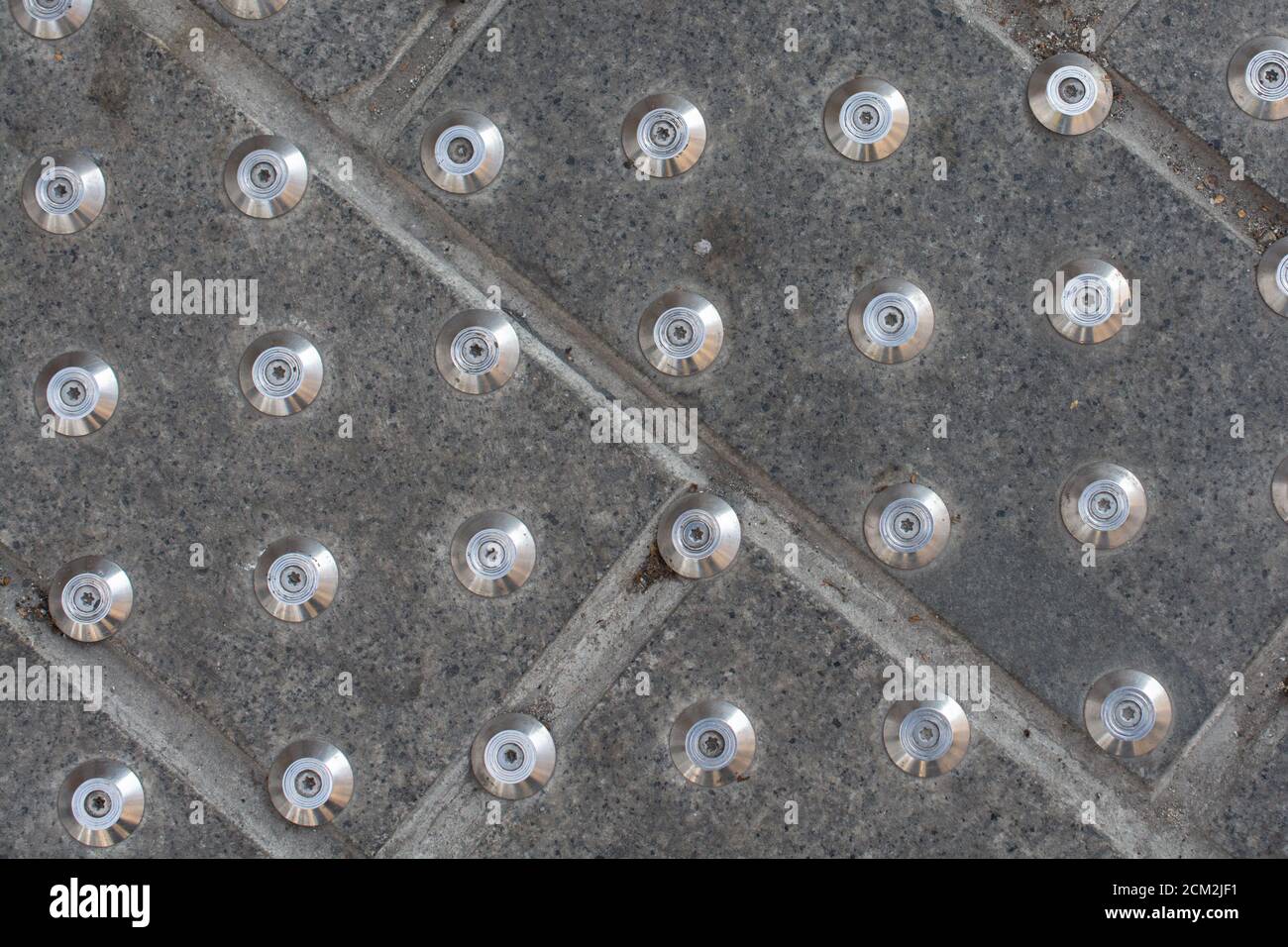 Paved pathway with gray tiles Stock Photo - Alamy