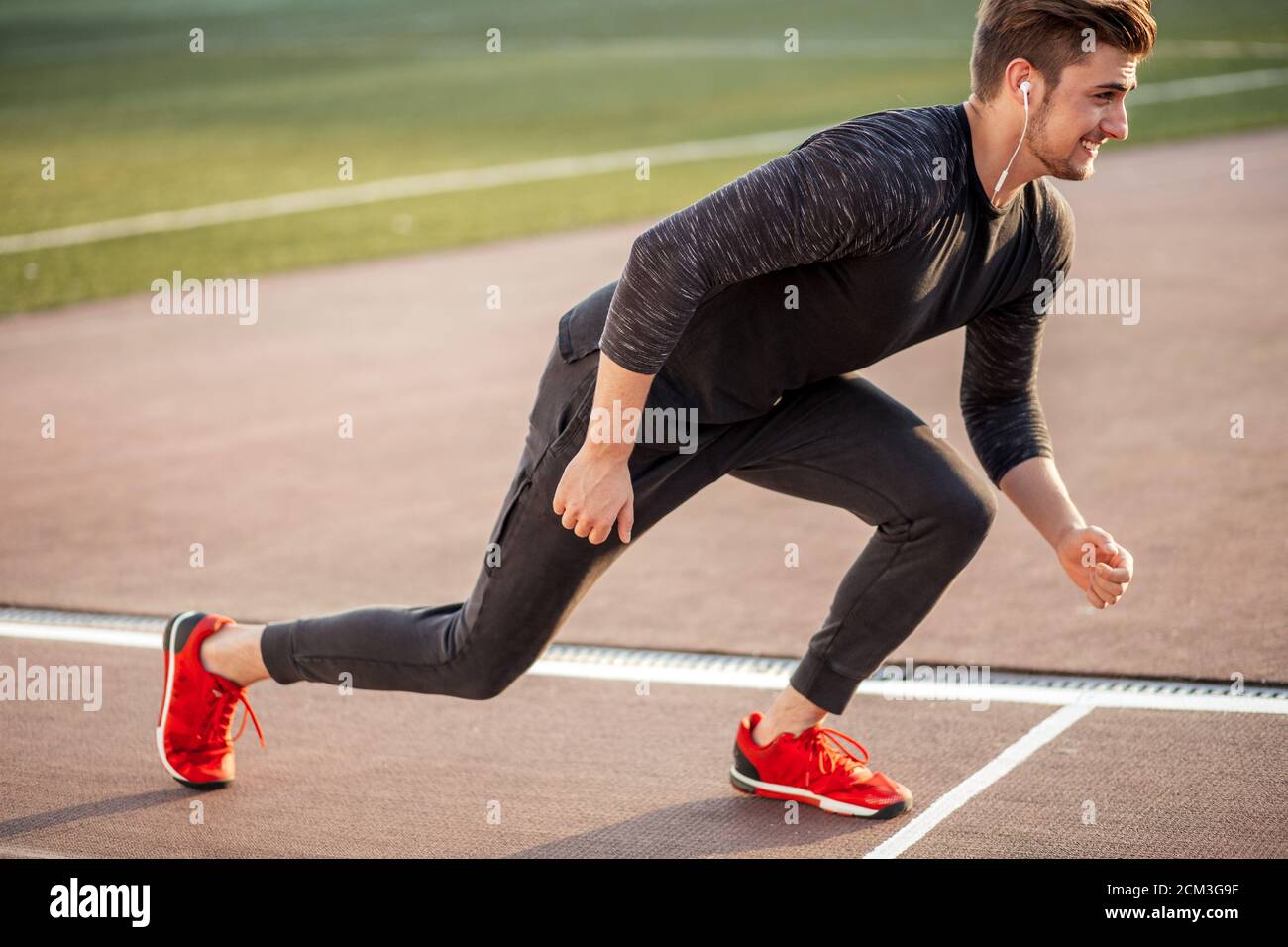 young male athlete launching start line in race track Stock Photo - Alamy