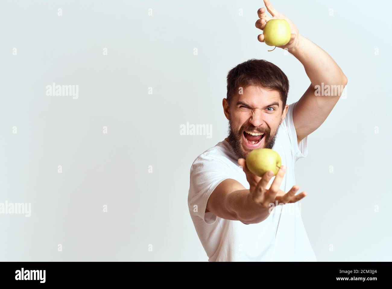 Energetic man with apples health vitamins diet and lifestyle white t ...