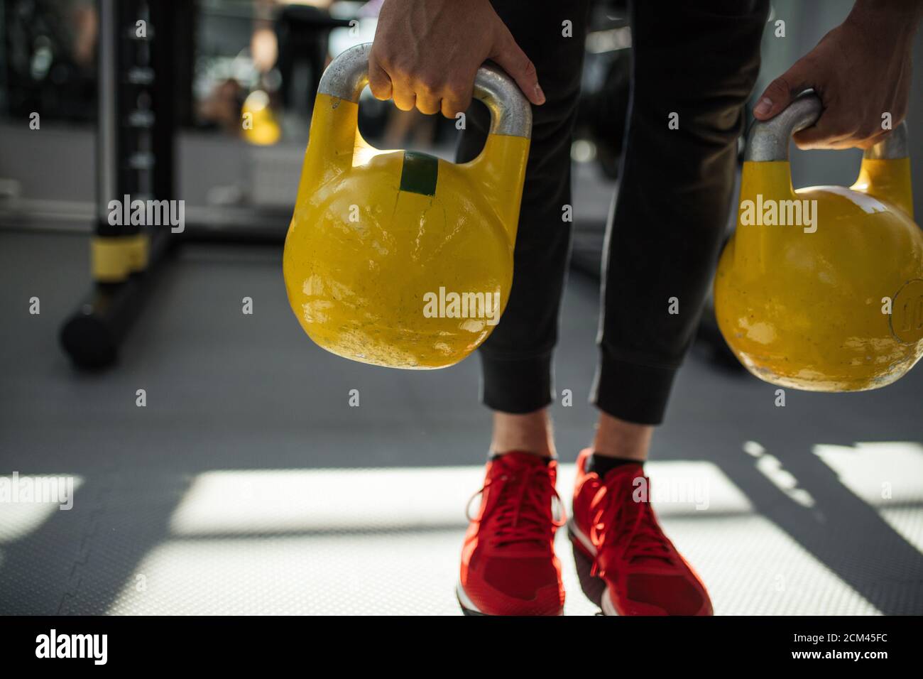 Male bodybuilder lifting kettlebells hi-res stock photography and ...