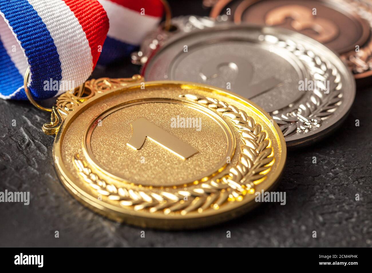 Gold, silver and bronze medal with ribbons. Award for first, second and ...