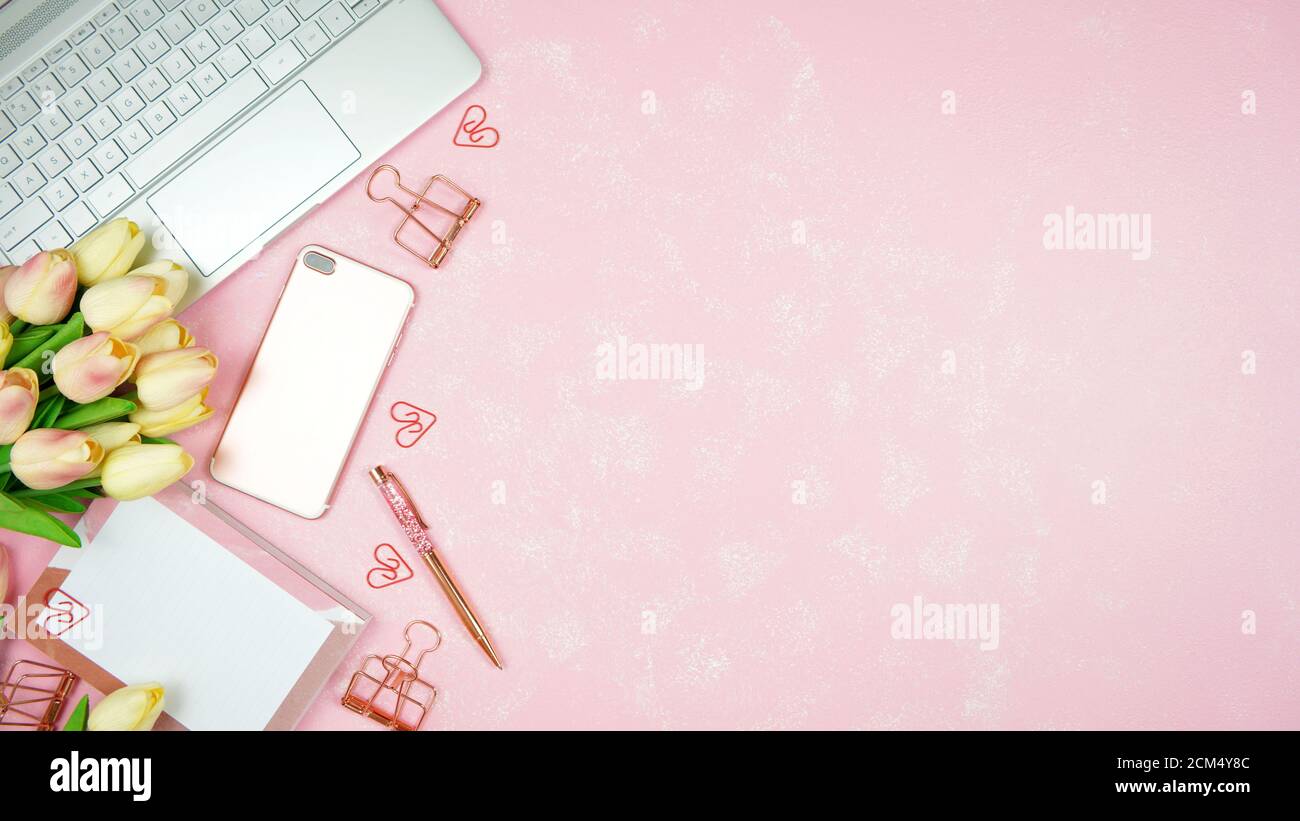 Feminine pink theme desktop workspace with laptop on stylish textured ...