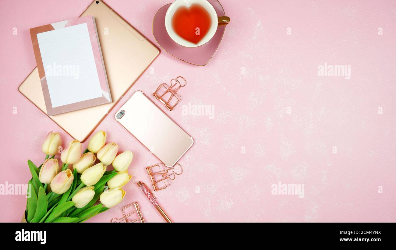 Feminine pink theme desktop workspace with rose gold tablet and phone ...