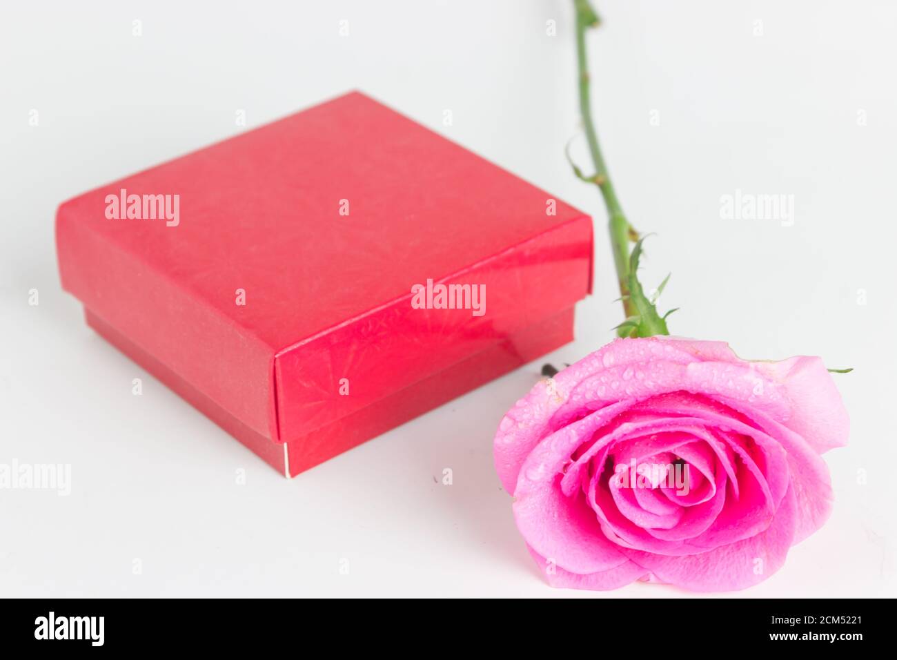 red gift box for love and romance with pink rose Stock Photo - Alamy