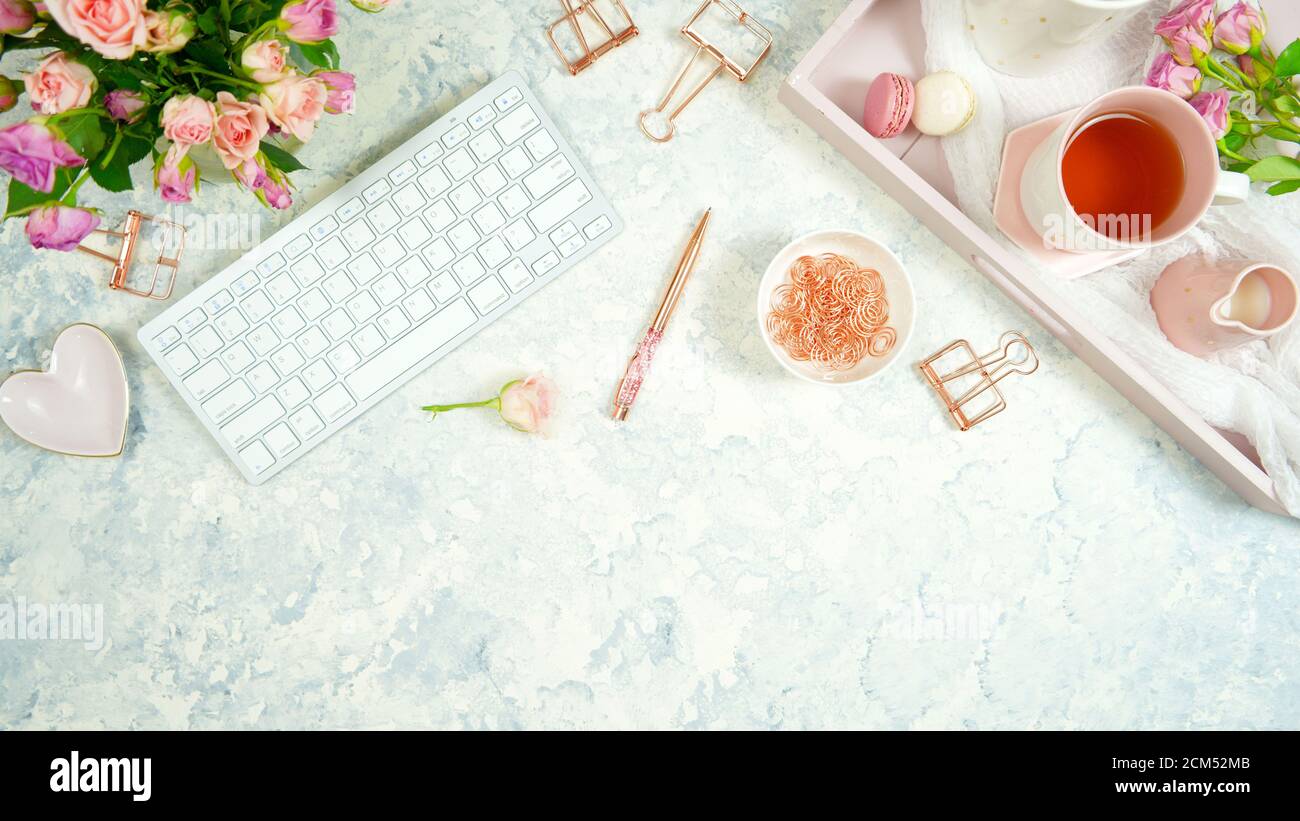 Blush pink theme cosy hygge desktop workspace with keyboard smart phone ...