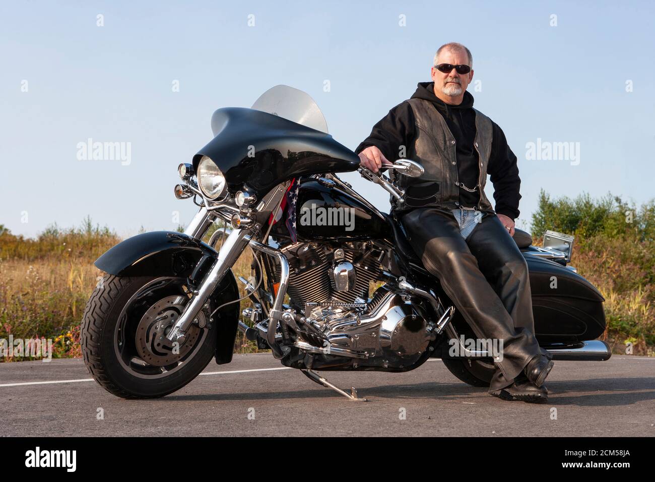 Man posing on his motorcycle Stock Photo - Alamy
