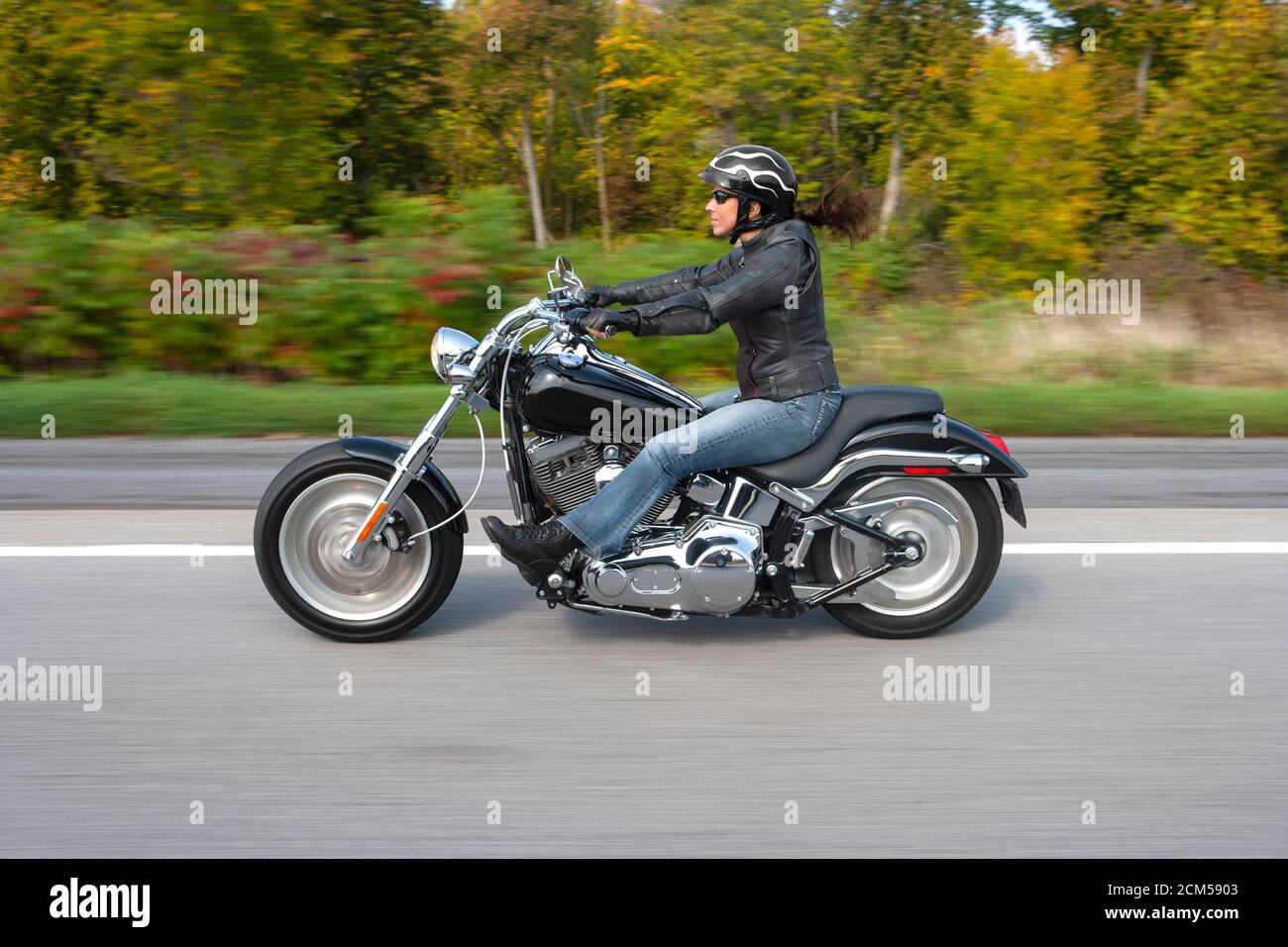 Woman riding motorcycle on highway Stock Photo - Alamy