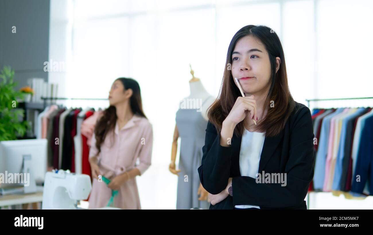 Portrait of young designers working in the garment factory Stock Photo ...