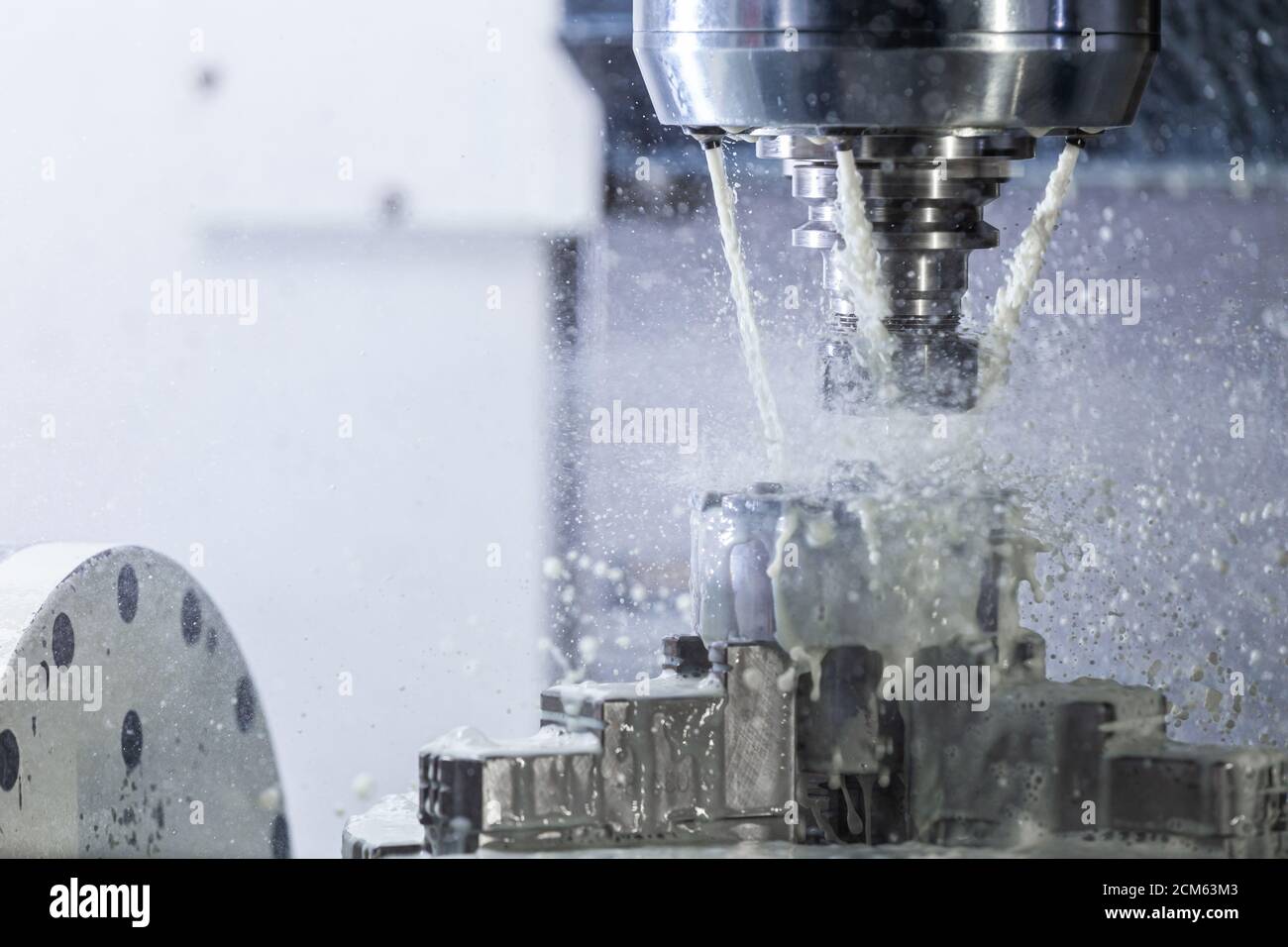 a process of industrial wet milling in 5-axis cnc machine with coolant ...